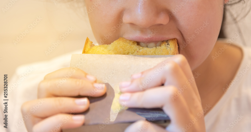 teenager girl biting butter bread. Stock Photo | Adobe Stock