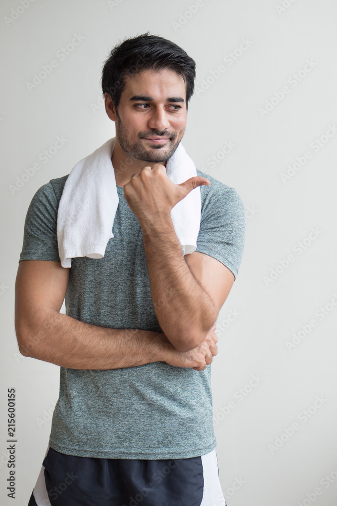 confident fitness man pointing thumb up gesture; portrait of happy ...