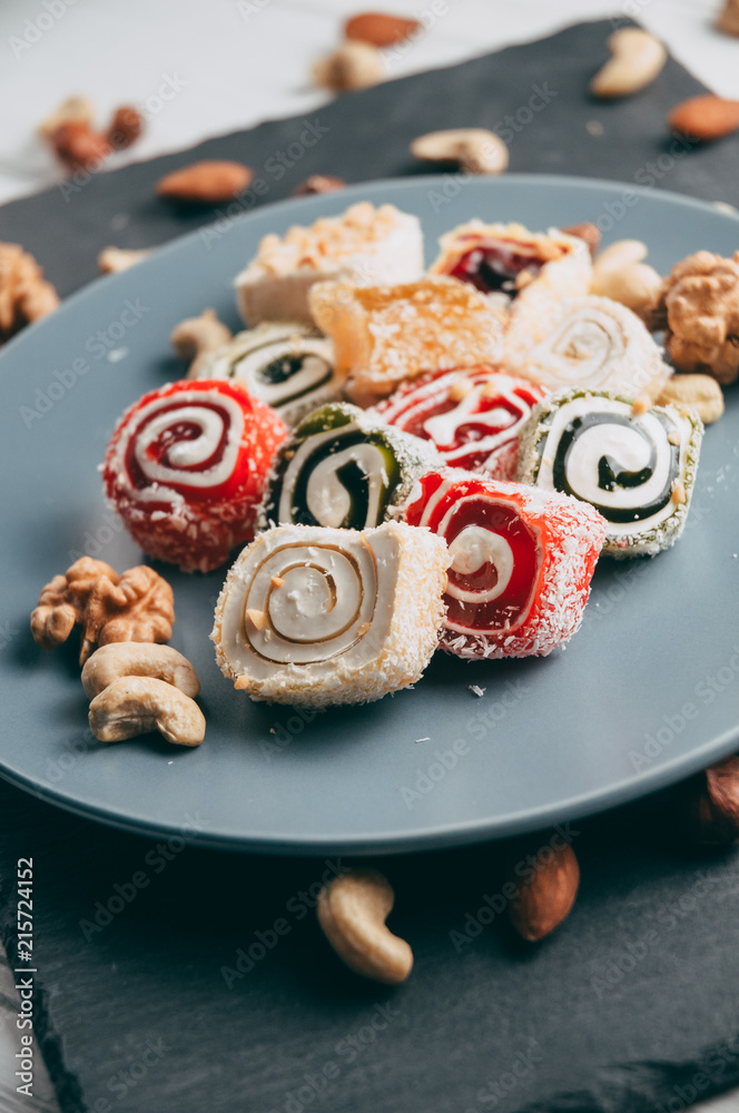 Traditional oriental sweets and nuts: hazelnuts, cashews on a white ...