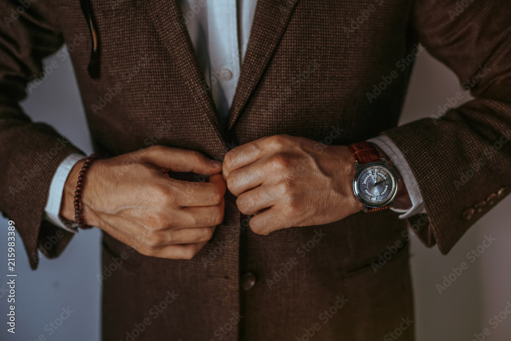 Man in suit fixing his cufflinks.Fashion portrait of young businessman ...