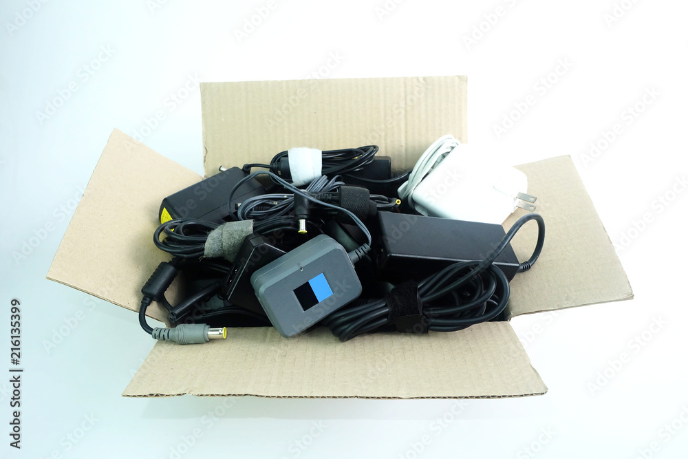 Paper box with the damaged or old used Adapter power charger of laptop ...