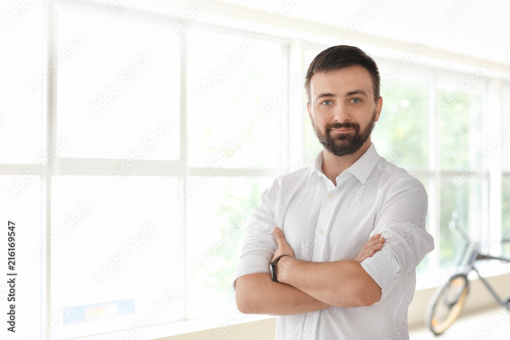 Portrait of handsome businessman in office Stock Photo | Adobe Stock