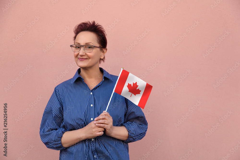 Canada flag. Woman holding Canadian flag. Nice portrait of middle aged ...