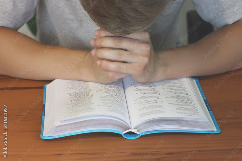 Open Bible. The guy is reading the Bible Stock Photo | Adobe Stock