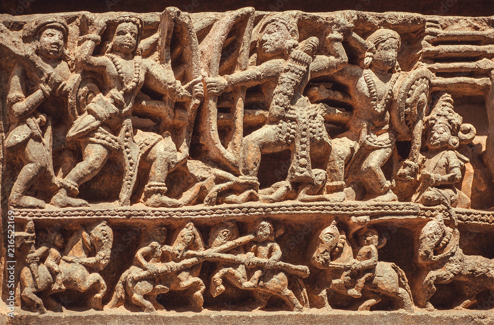 South Indian temple relief with battle scene. warriors and riders with ...