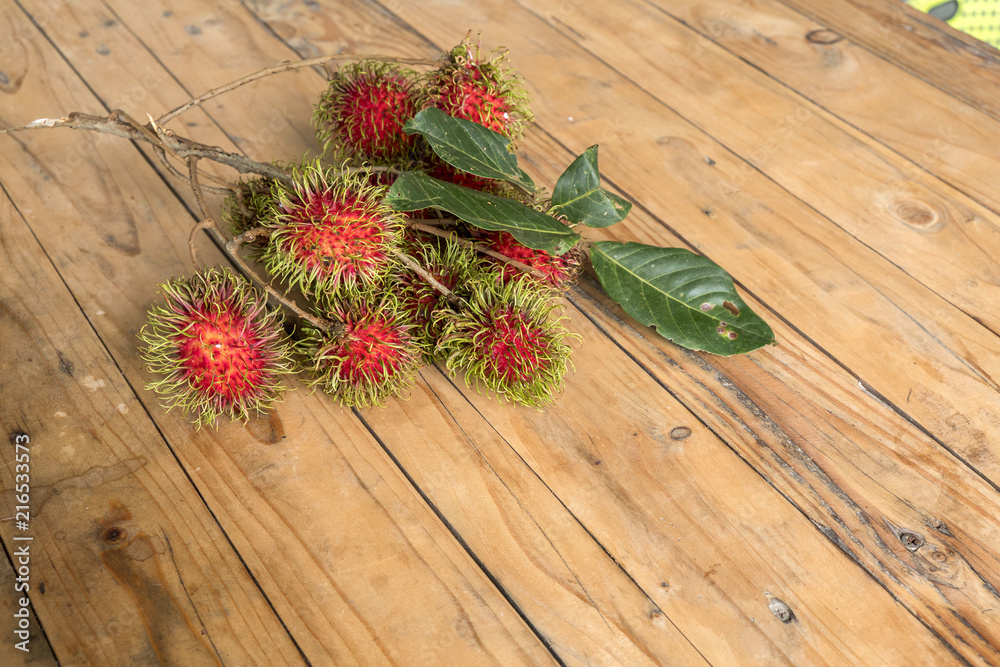 Red rambutan Nephelium lappaceum on broun board. Fruit tropical tree of ...