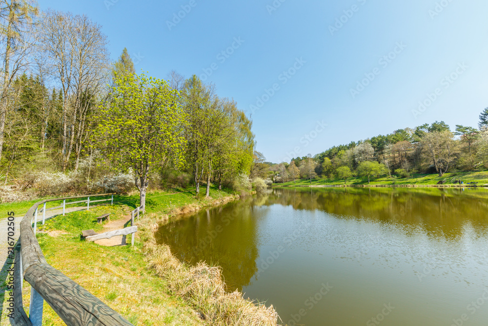 Lake Stausee in the hills at the German town of Gerolstein surrounded ...
