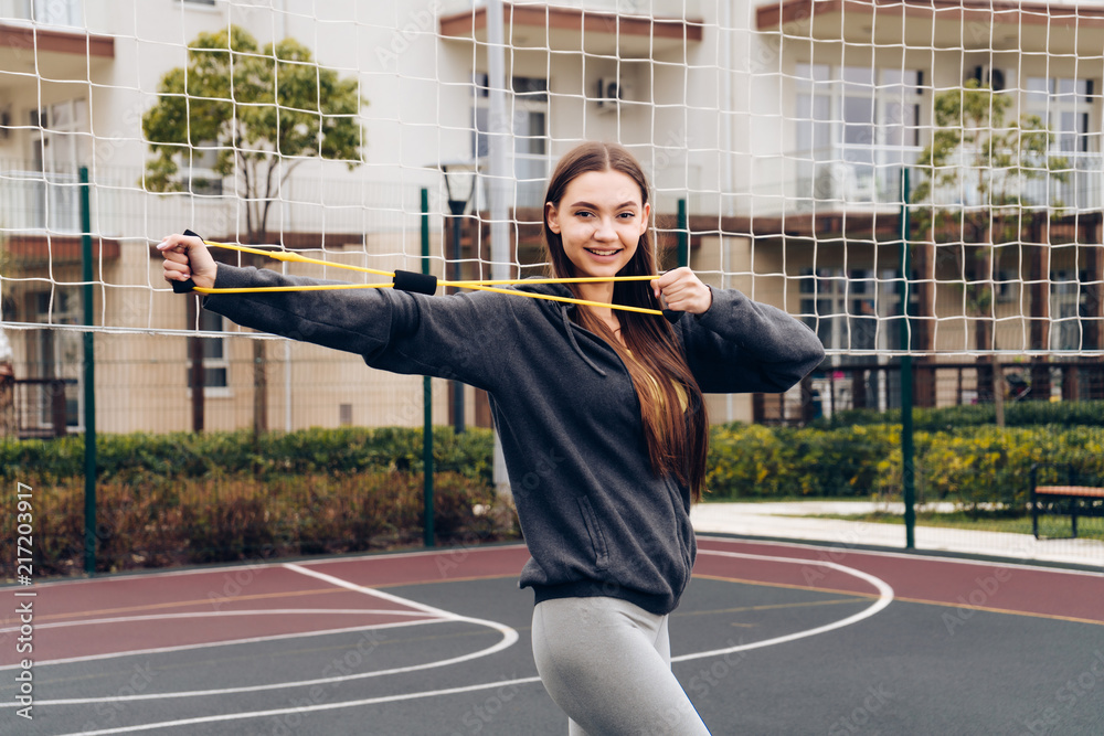 strong young girl doing exercises for the muscles of the hands, wants a ...