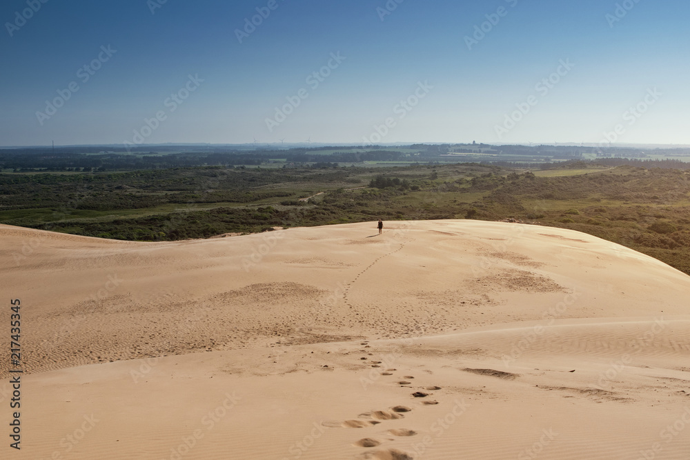 ootsteps in the sand of a endless beach dune landscape like a desert in ...