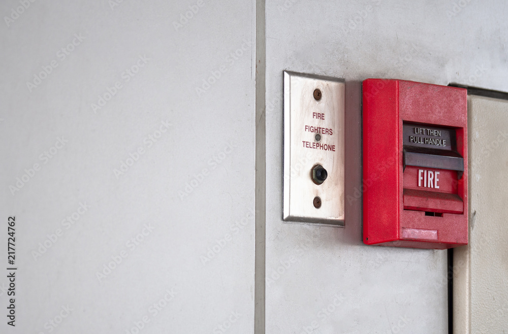 Push button switch, fire alarm on grey wall for alarm and security ...