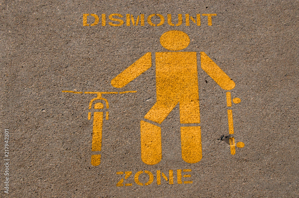 “Dismount Zone” marked on sidewalk outside busy shopping center Stock ...