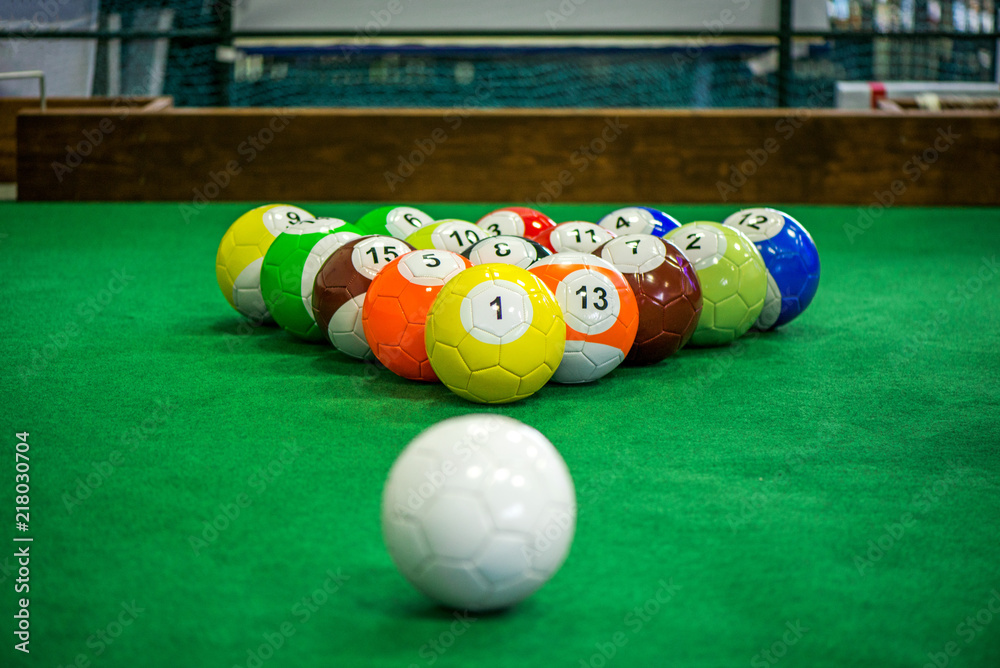 Shot of foot pool balls standing on green table. Foot Pool is the ...