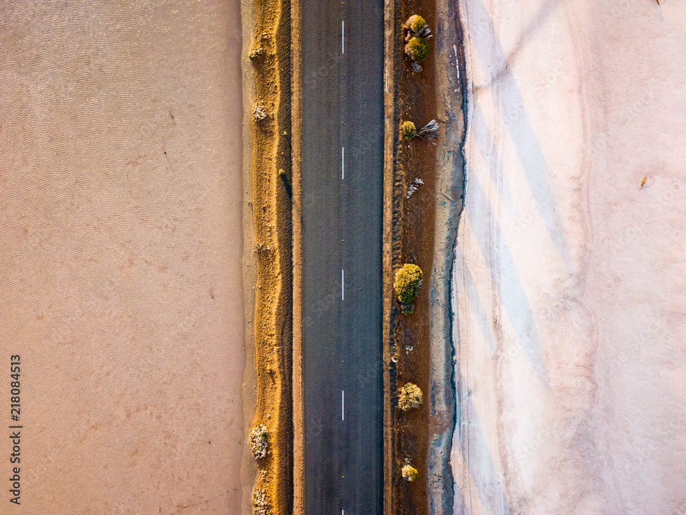 Top down aerial photo of a road (highway) leading through an arid salt ...