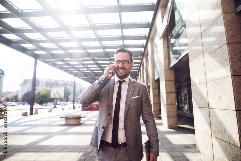 Smiling young businessman walking with confidence to a new business ...