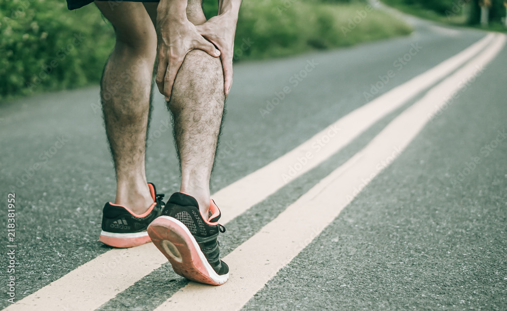 Sport injury. Accident concept,Young fitness man holding his sports leg ...