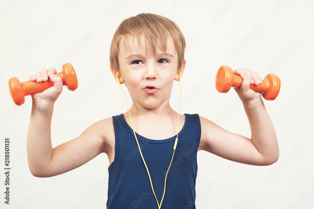 Healthy little boy working out with dumbbells over white background ...