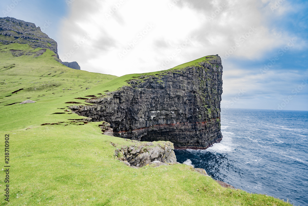 Amazing dramatic view of steep cliff in front of Drangarnir in Vagar ...