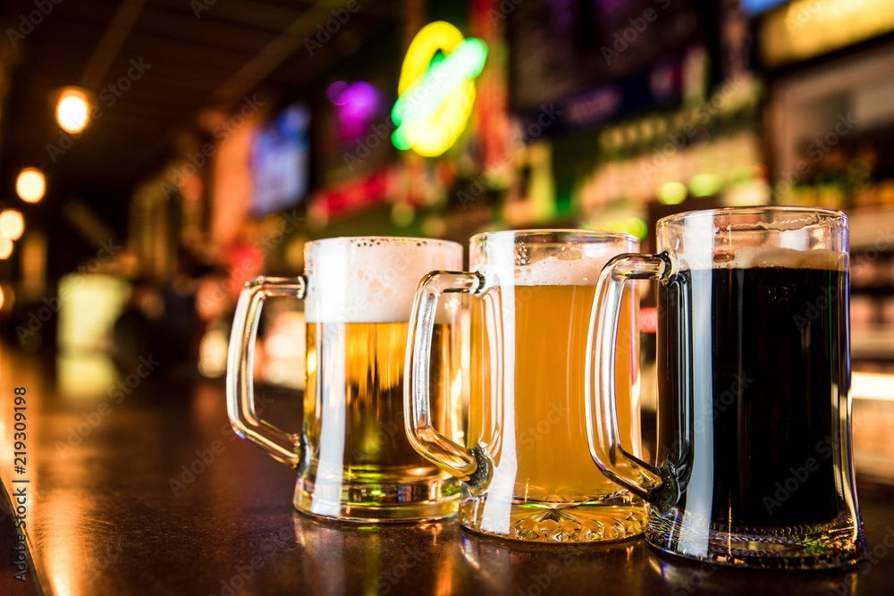 Three glasses of beer on a table in bar background Stock Photo Adobe Stock
