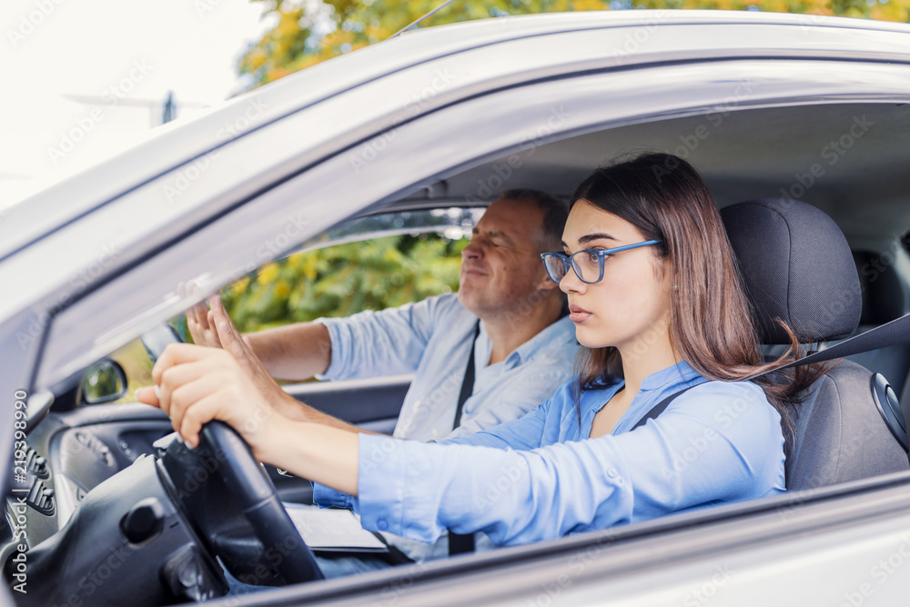 Driving school or test. Beautiful young woman learning how to drive car ...