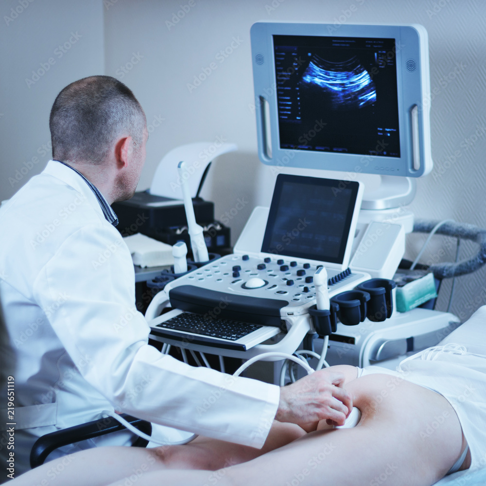 Doctor doing ultrasound scan. Pelvic ultrasound Stock Photo | Adobe Stock