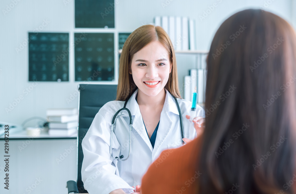Young asian doctor showing hand press syringe ready to inject shot ...