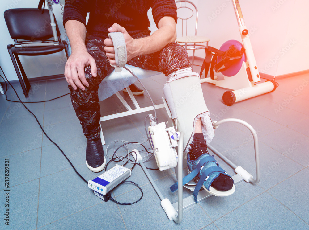 Patient on CPM (continuous passive range of motion) machines. Device to ...