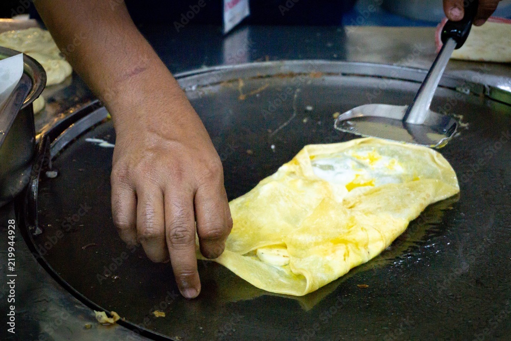 Стокове фото Famous Asian pancake, known as roti canai. The making of ...