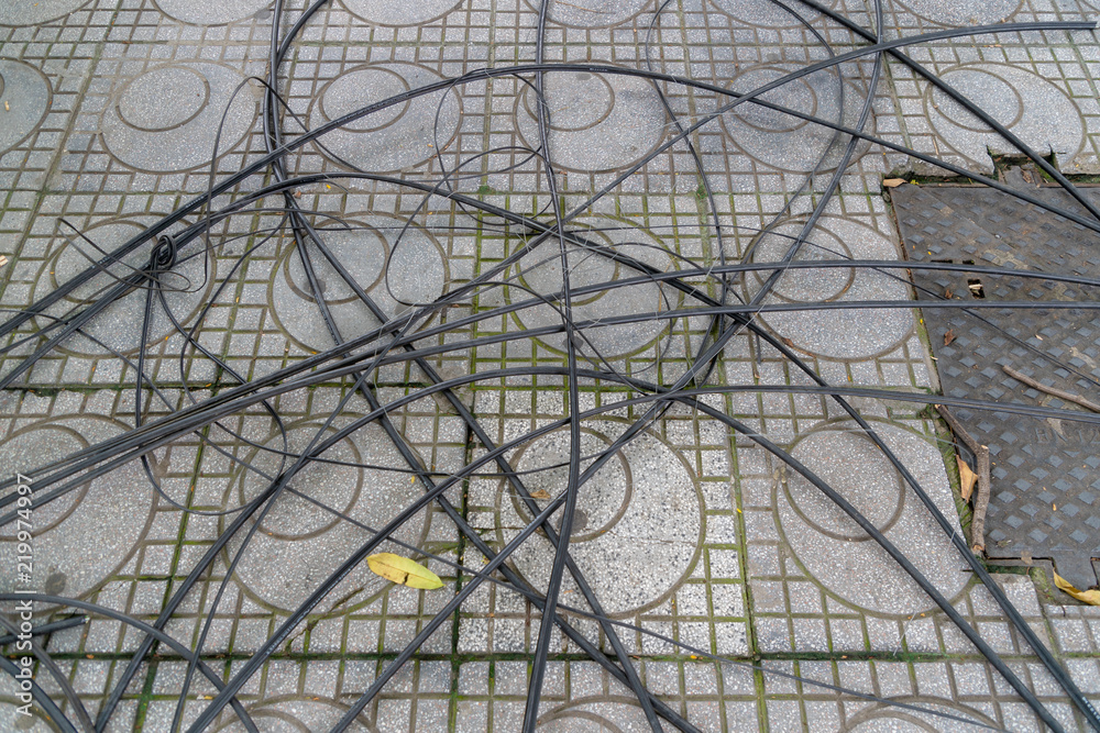 Power cord and Cable power tangled on the Walkway, floor and square ...