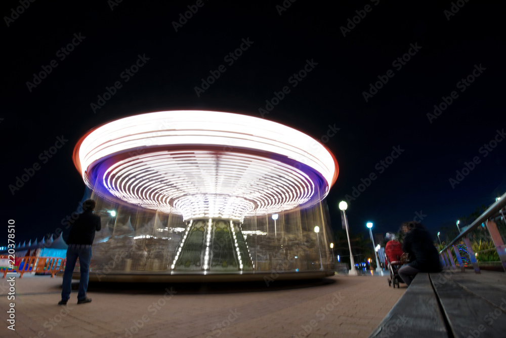 Abstract, long exposure shot of spinning Children's vintage Carousel at ...