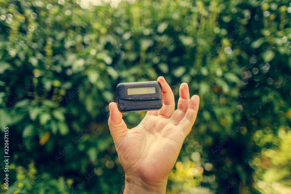 pagers. old vintage beeper. pager in hand Stock Photo | Adobe Stock
