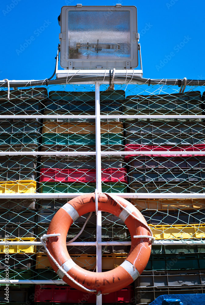 fishing boat with plastic crete piled up prepared for the catch with a ...