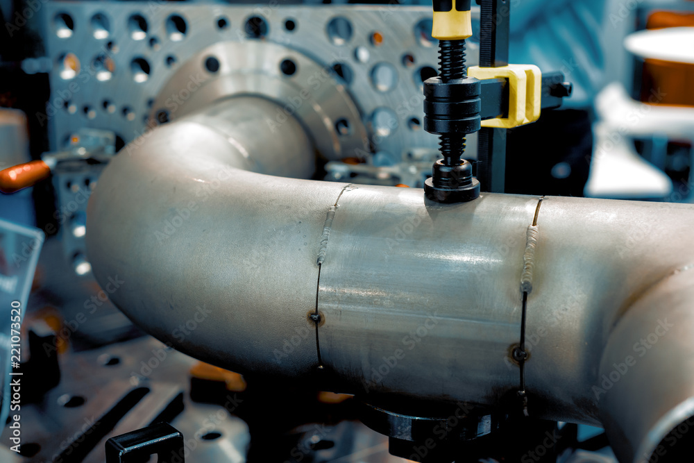 Elements of a thick metal pipe are installed in the clamping system ...