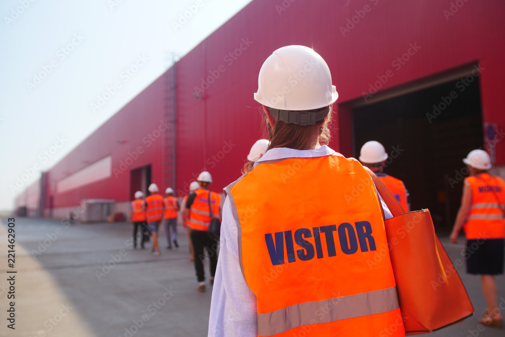 factory inspection. group of visitors on the factory tour. people go in ...