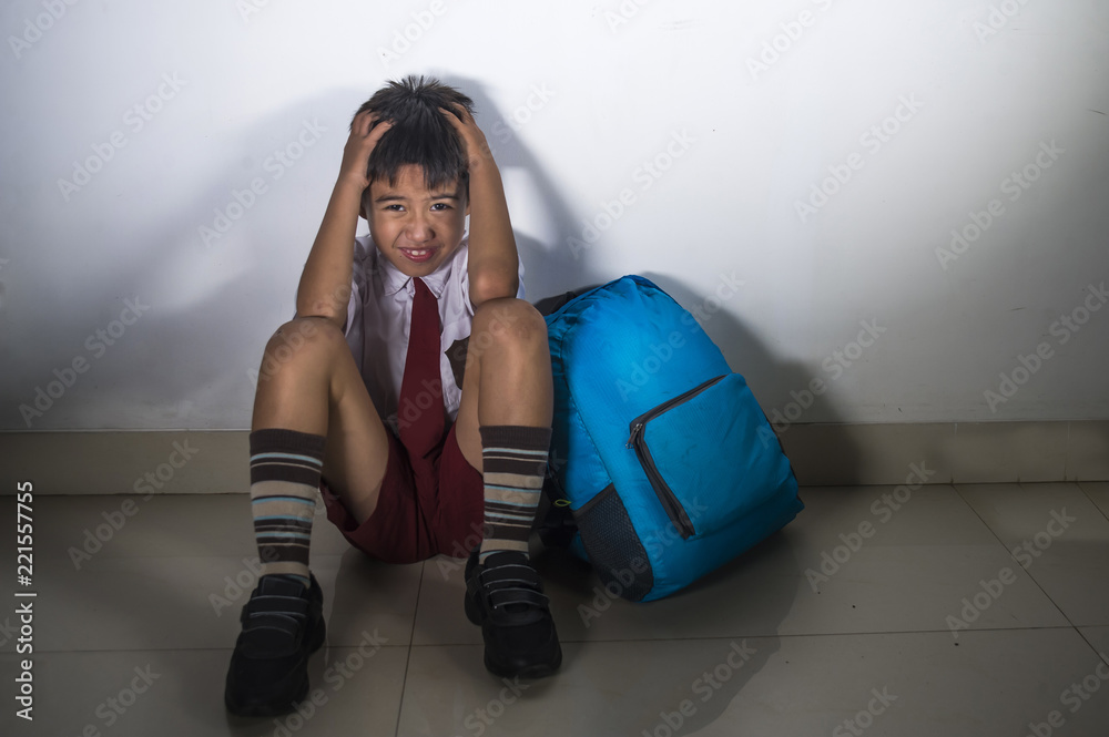 young sad scared kid 8 years old in school uniform and backpack sitting ...