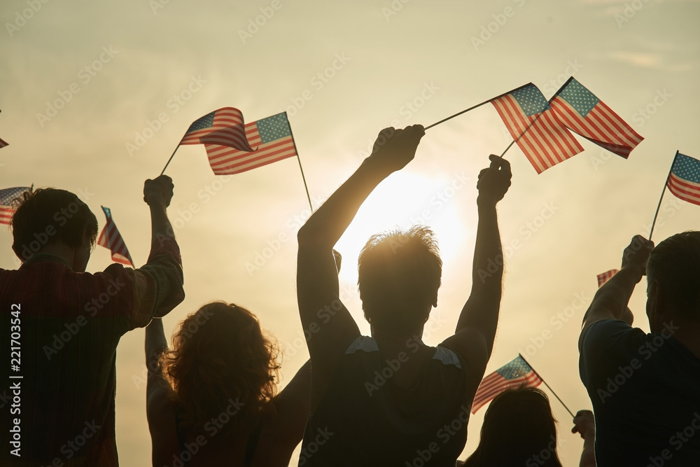 Crowd of people holding american flag, back view. Silhouette of ...