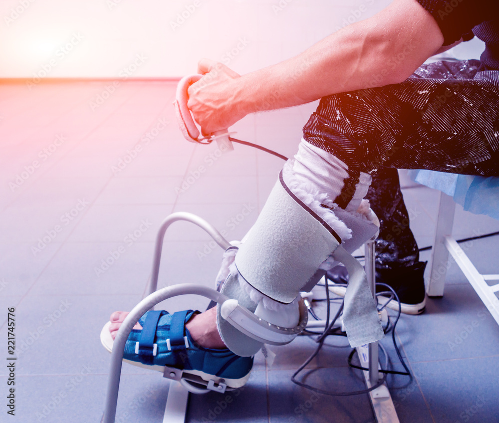 Patient on CPM (continuous passive range of motion) machines. Device to ...