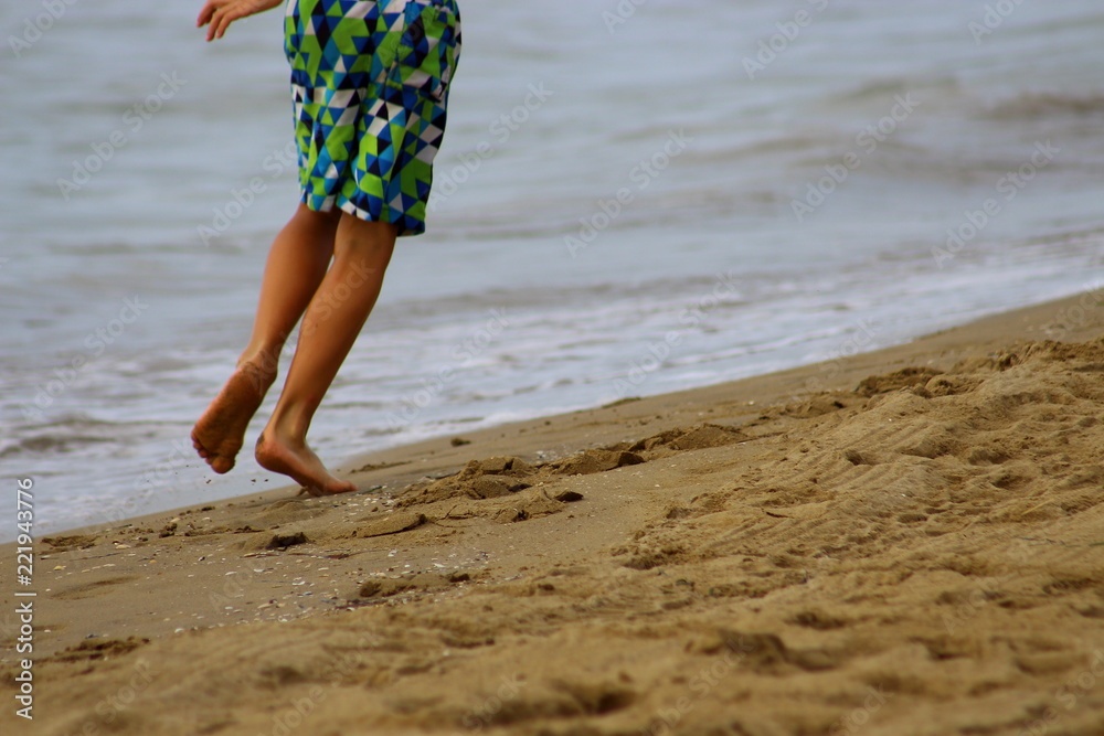 Boy feet step on the sea wave Stock Photo | Adobe Stock