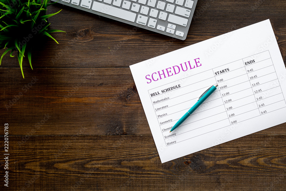 School student's schedule with time of lessons on dark wooden office ...