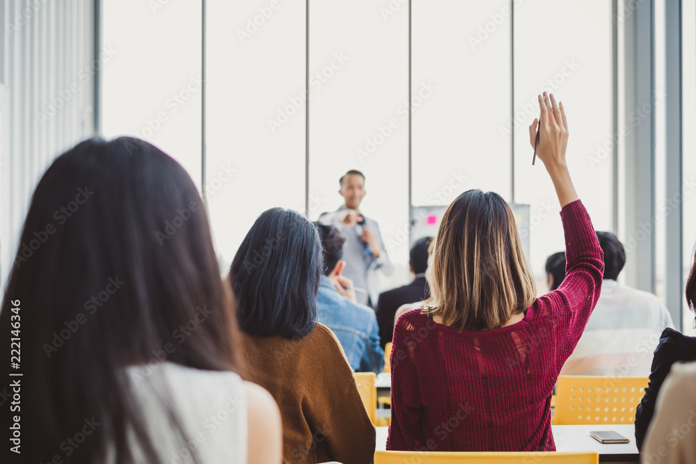 Business woman raising hand for asking speaker for question and answer ...
