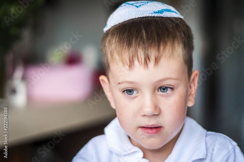 A beautiful blue eyed Caucasian kid with a traditional Jewish kippah ...