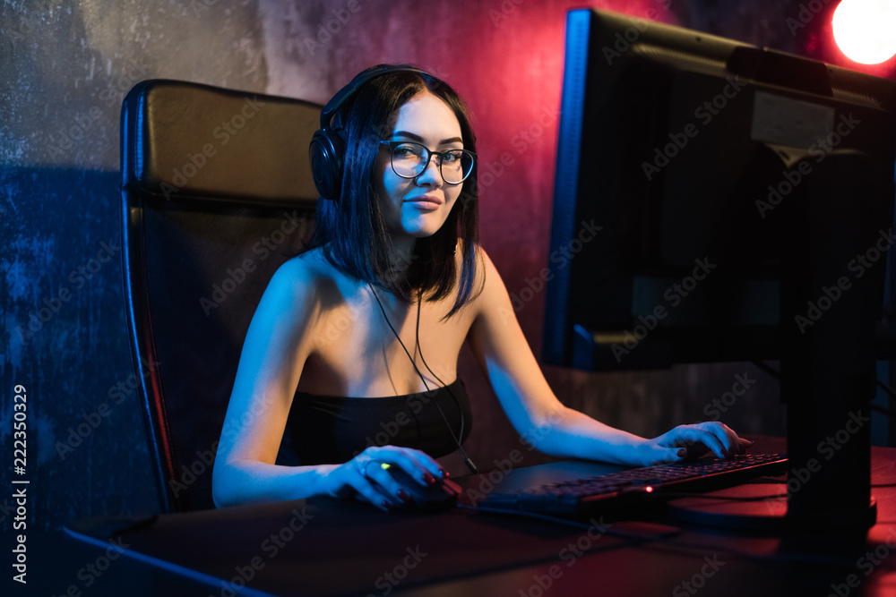 Portrait of the beautiful professional gamer girl playing in online ...