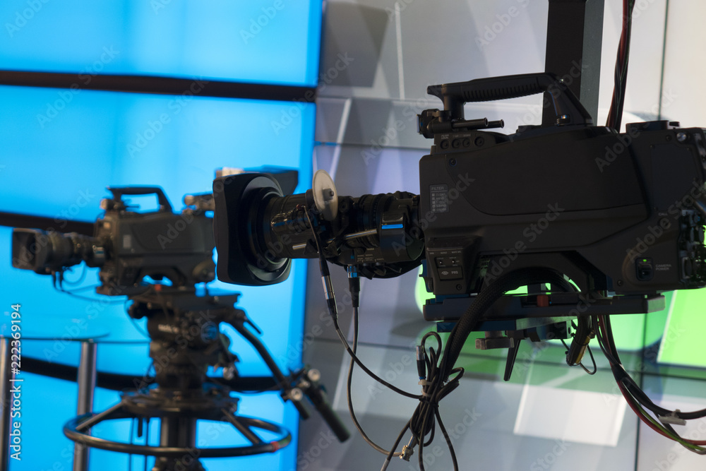 Broadcast television studio camera and crane camera in news studio room ...