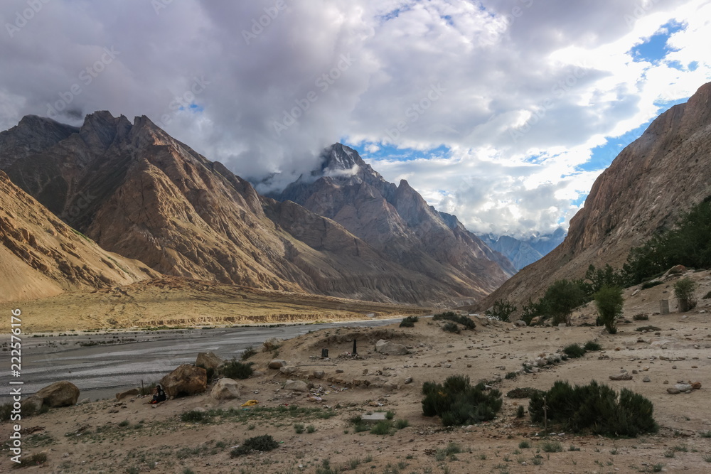 The river flows through the hills and mountain in the Askole village ...