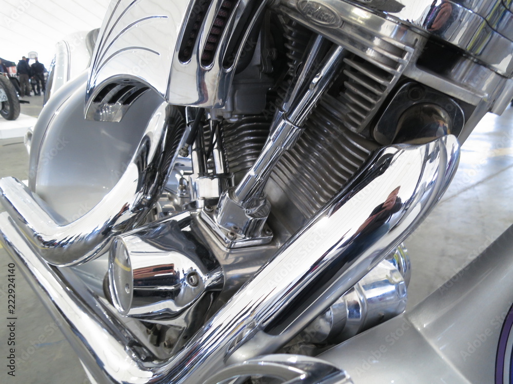 Chrome motorcycle engine parts close-up. The engine and exhaust system ...