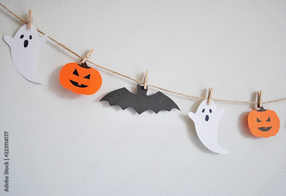 Halloween paper garland with ghost, pumpkin and bat hanging on the wall ...