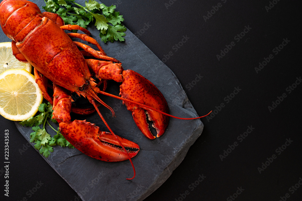 lobster with vegetable and lemon on black slate plate Stock Photo ...
