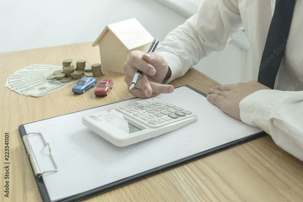 The young man is checking his company's finances to determine whether ... The young man is checking his company's finances to determine whether ...