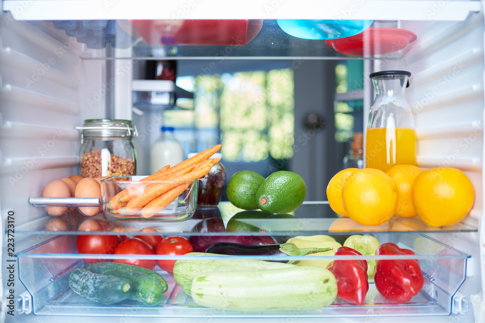 Opened fridge from the inside full of vegetables, fruits and other ...