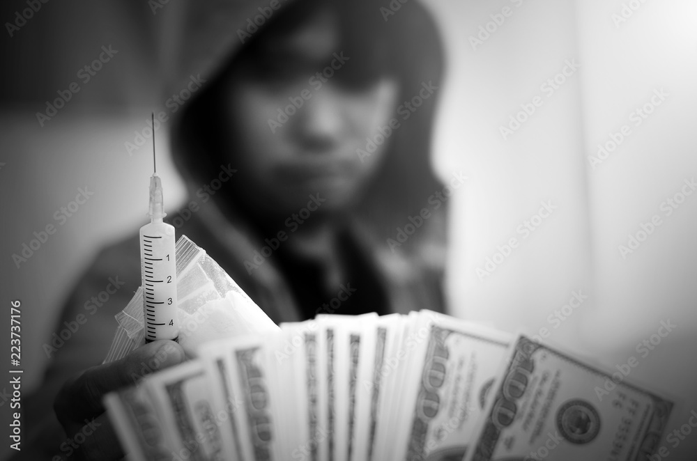 Concept: the Asian men are buying-selling drugs with dollars ...