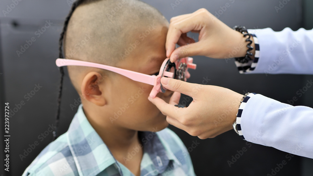 eyesight check. Asian boys who have vision disabilities. Left eye is ...